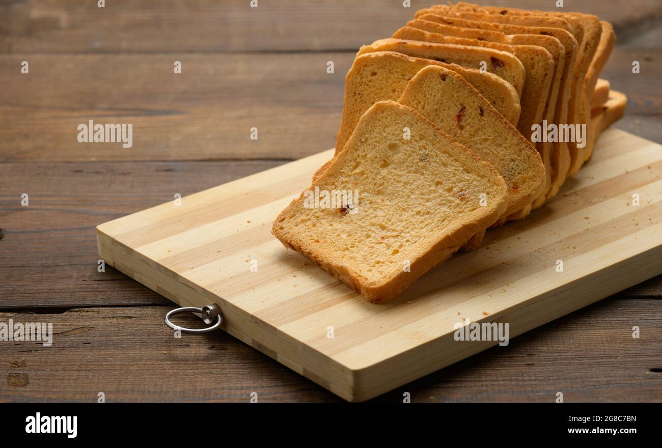 sliced white wheat flour bread on a wooden board. Sandwich bread Stock ...