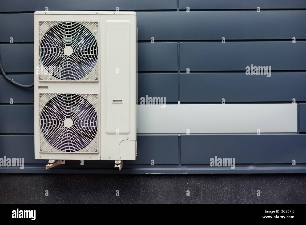 Air compressor installation on metal tiled wall of modern building ...