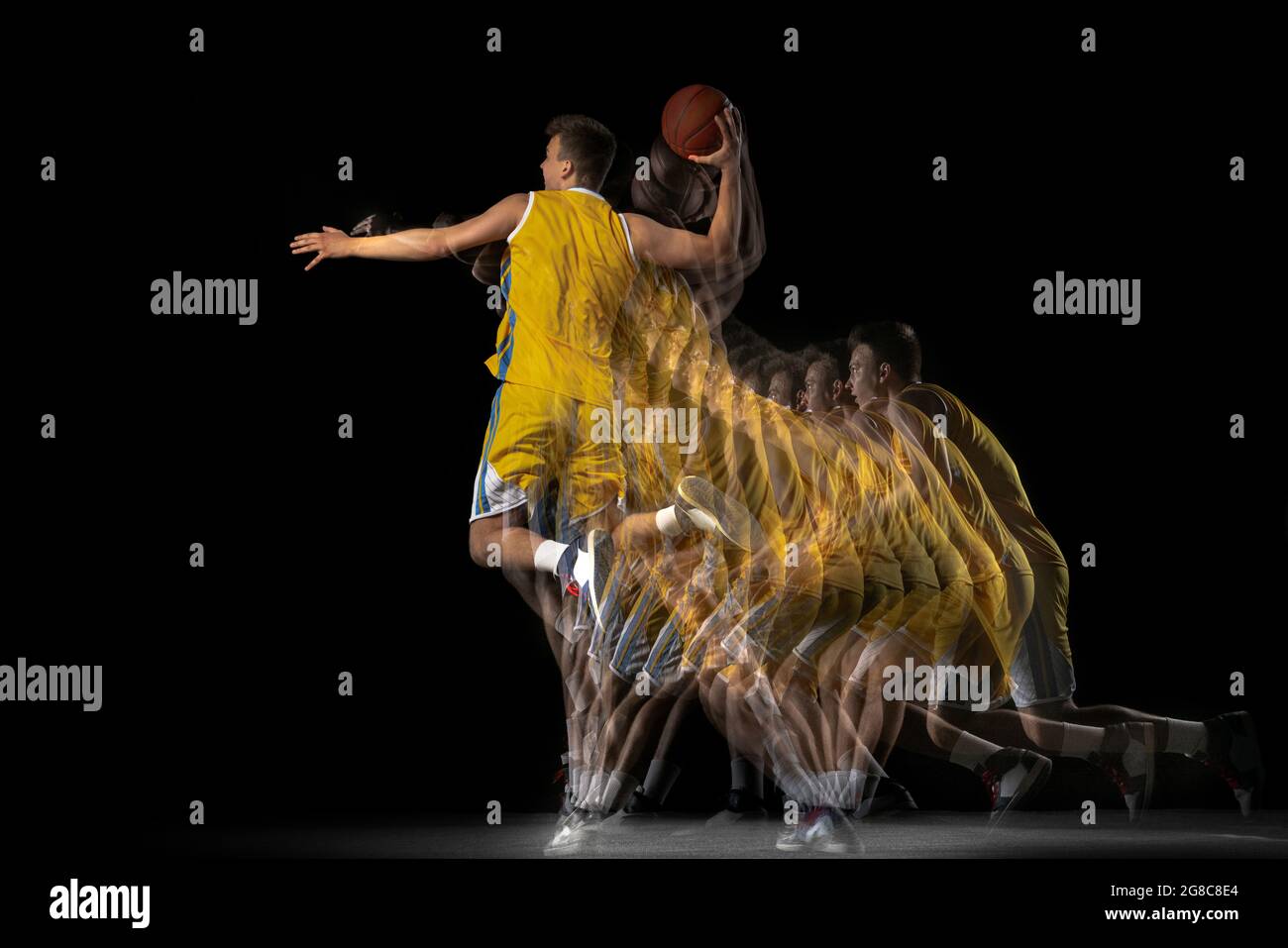 Young caucasian basketball player in motion and action isolated on dark ...