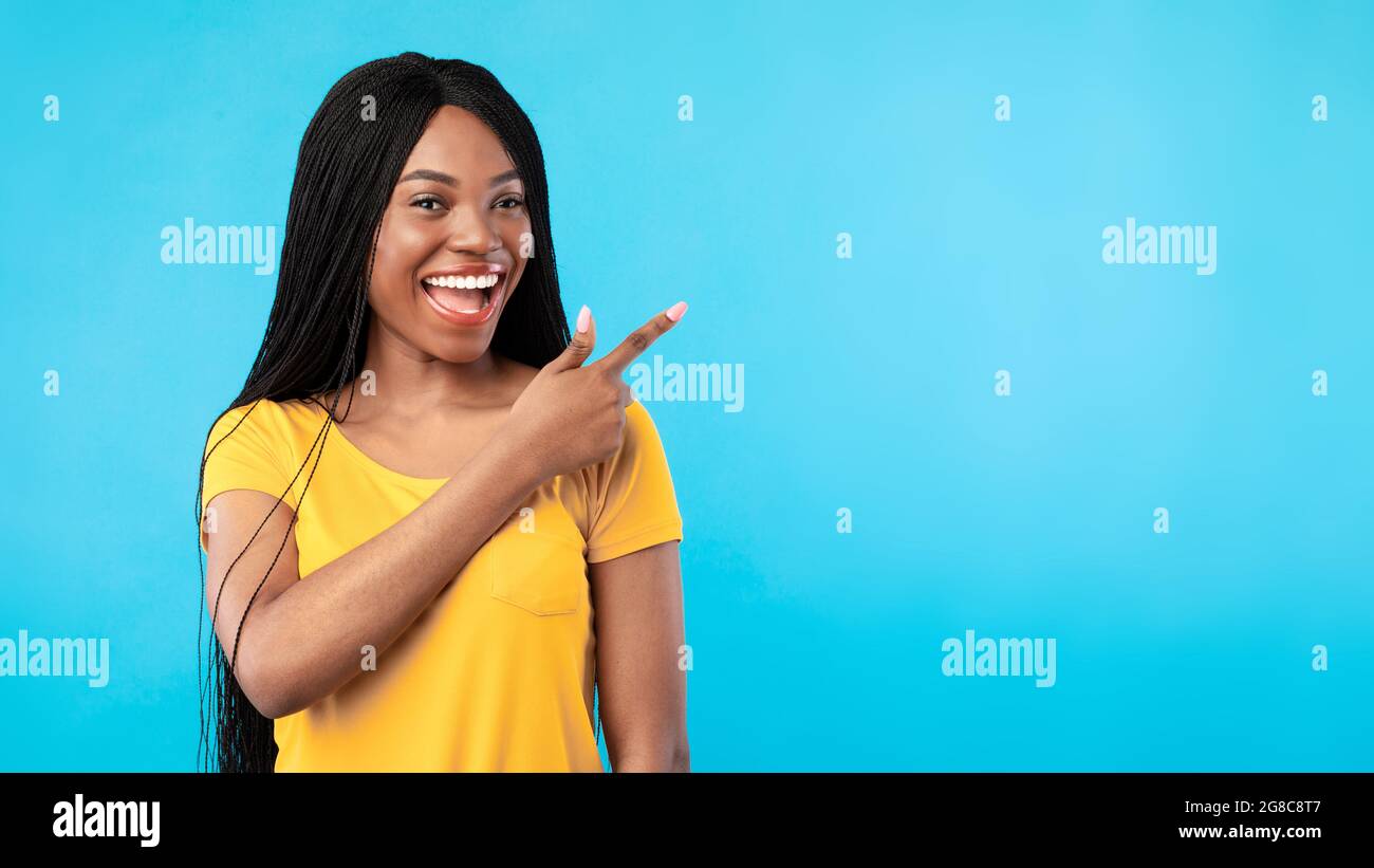Black Female Pointing Finger Aside Showing Copyspace, Blue Background ...