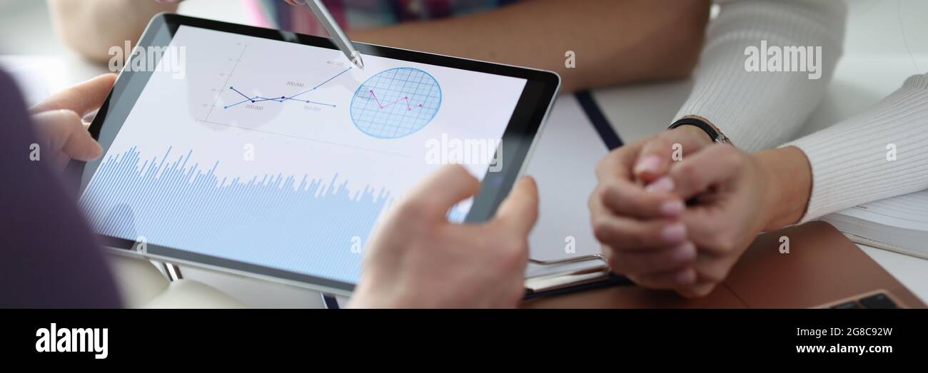 Group of people discussing graph on digital tablet closeup Stock Photo ...