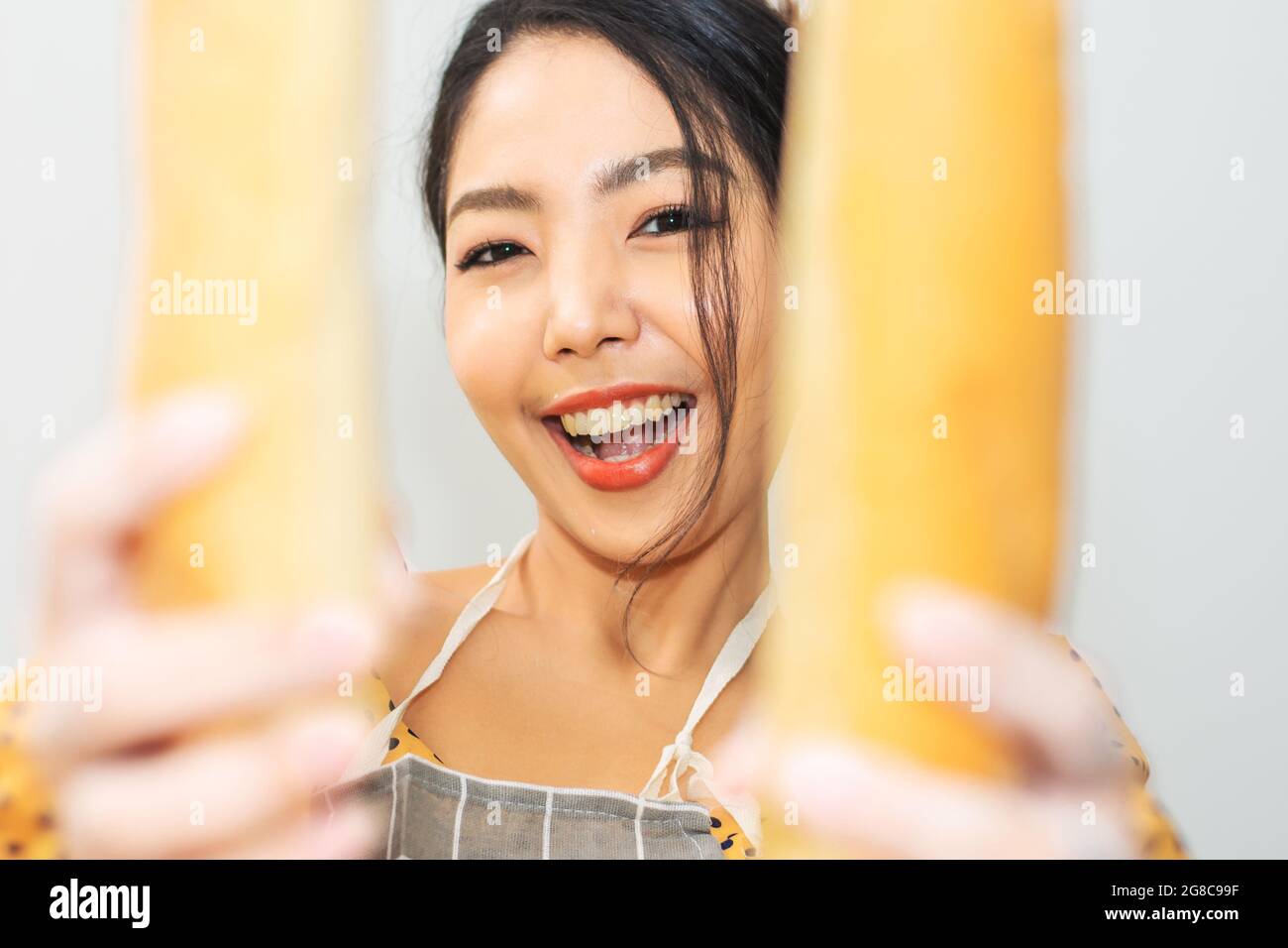 Portrait Woman happy with bread in bread shop, Women holding bread ...