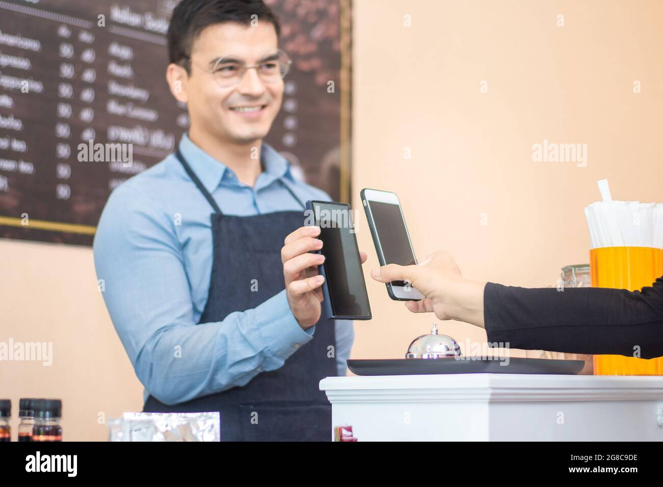 People using smartphone mobile banking scan QR code to pay in shop ...