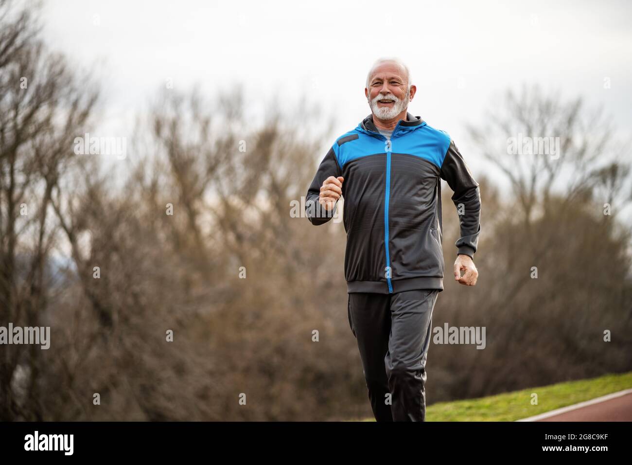 Active senior man is jogging. Healthy retirement lifestyle Stock Photo ...