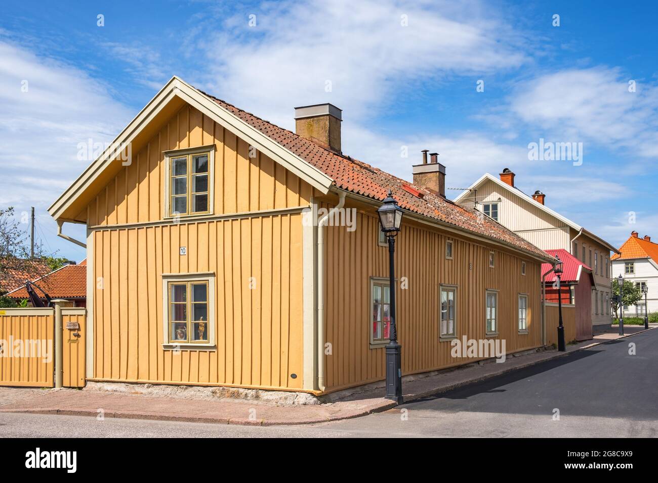 Old idyllic wooden house on a city street Stock Photo - Alamy