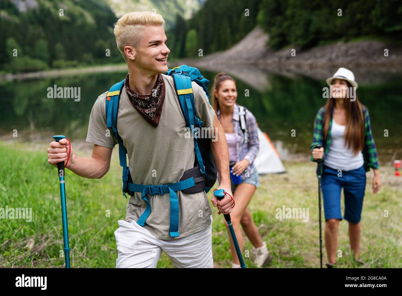 Hiking with friends is so fun. Group of young people with backpacks ...
