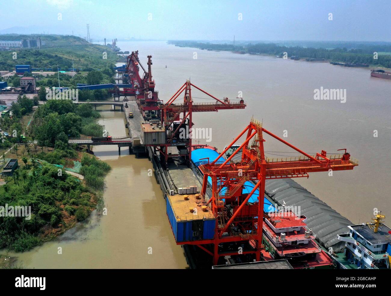 Machines unload and upload goods at the Tongling Port in Tongling city ...