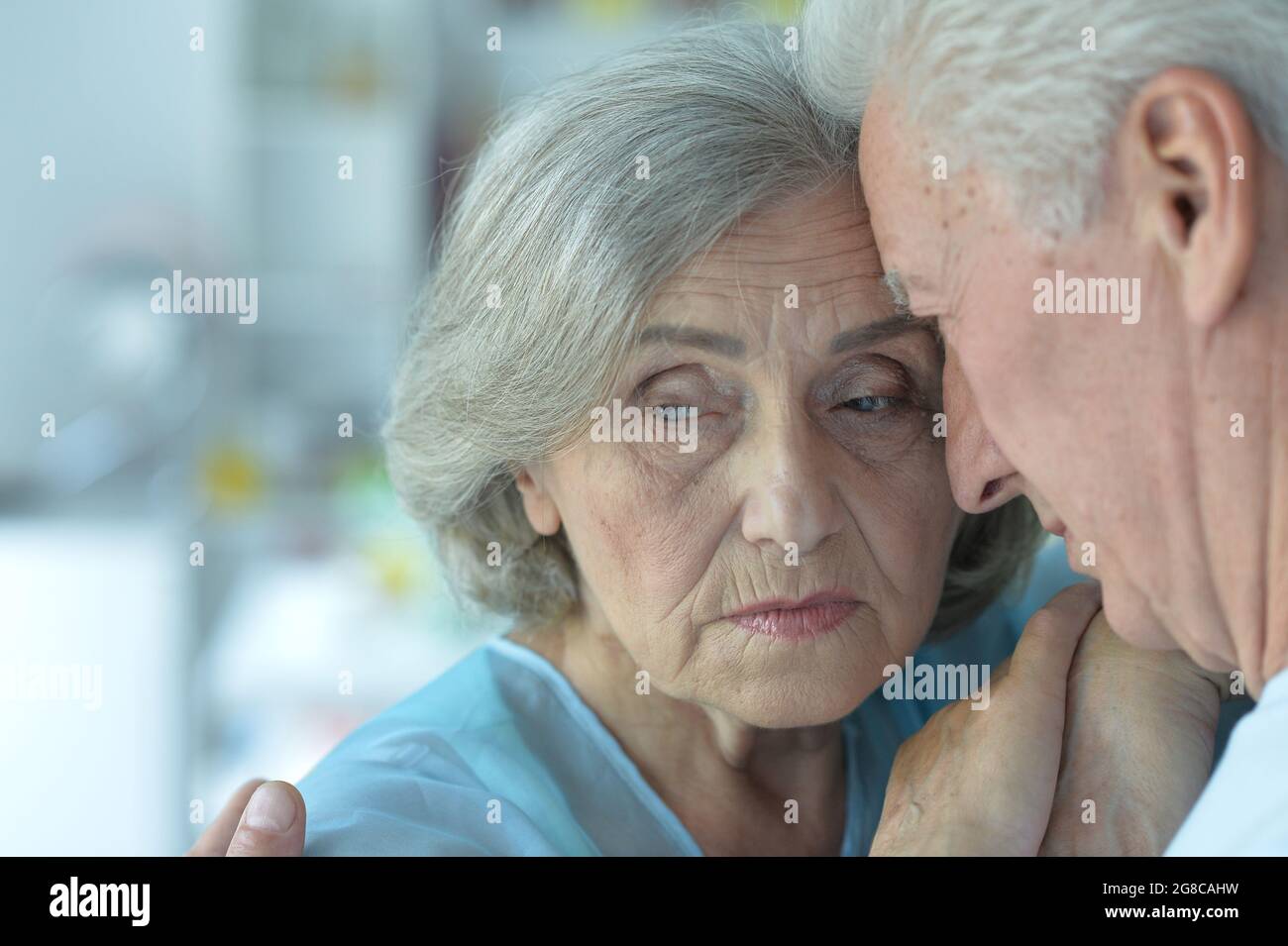 Portrait of sad senior couple posing at home Stock Photo - Alamy
