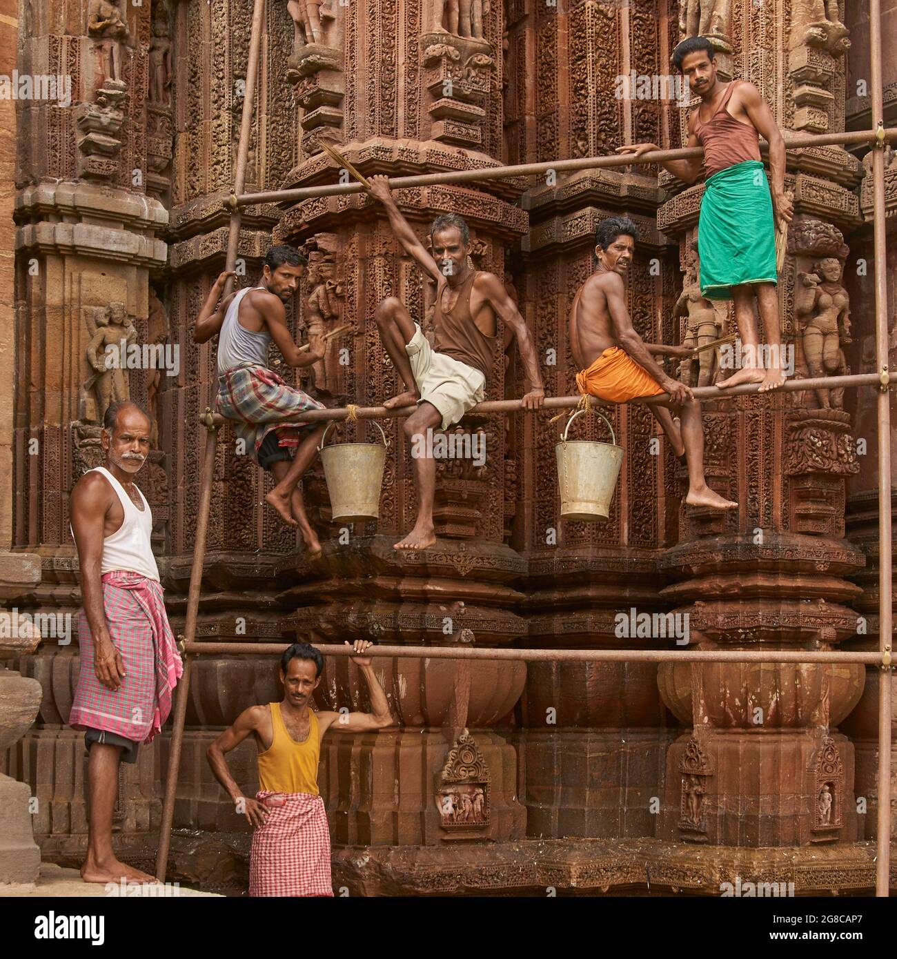 Group of men on scaffolding cleaning and restoring the ancient Rajarani ...