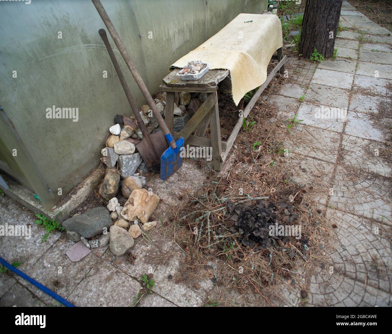 Pile of rubbish and hand tools in a backyard, outdoor shot Stock Photo ...