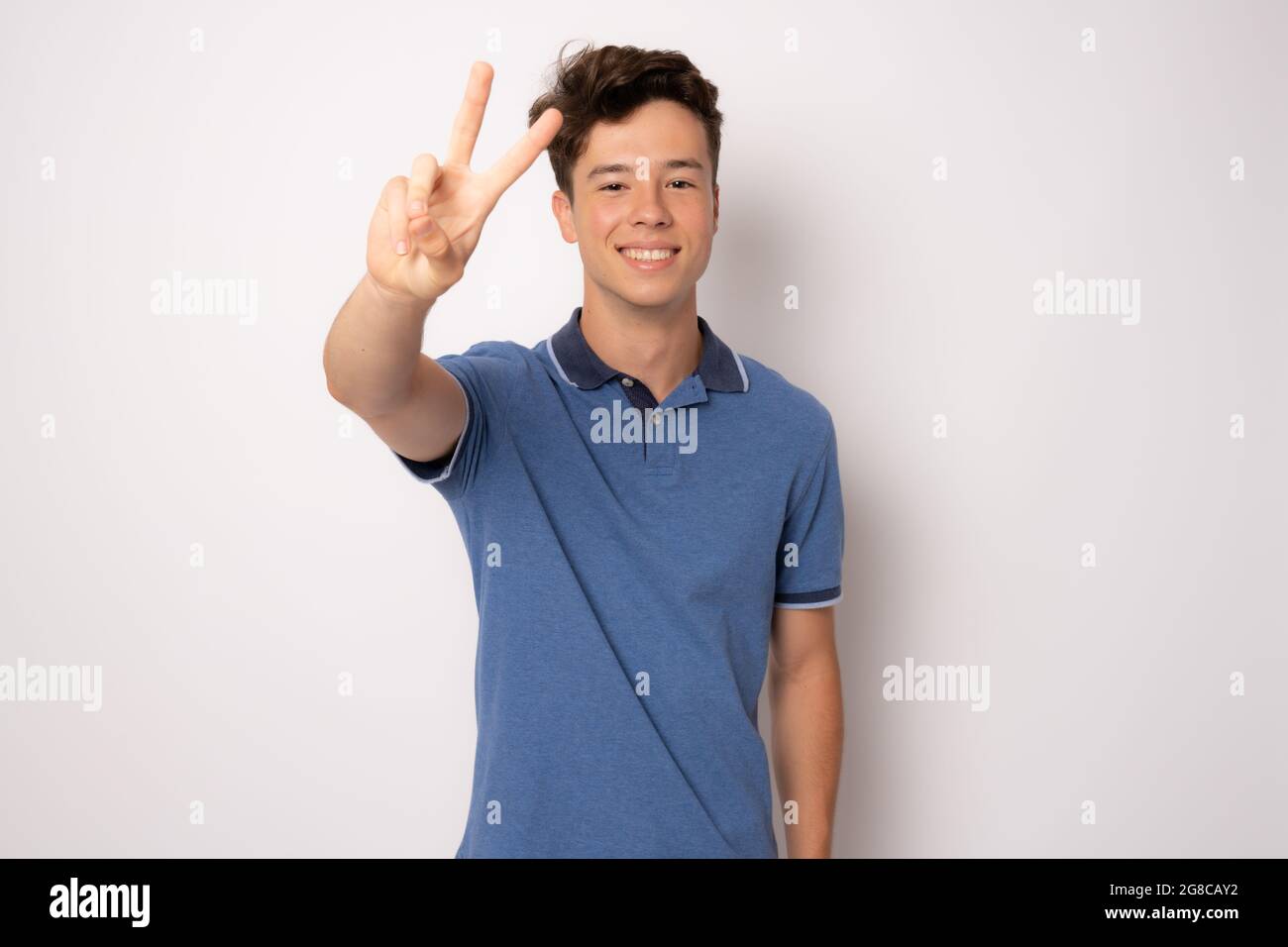Victory sign positive young man hi-res stock photography and images - Alamy