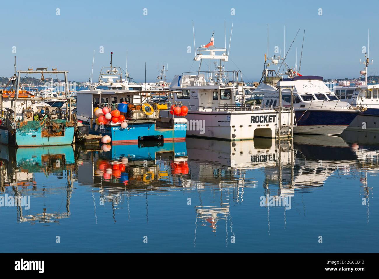 Boats moored in Poole Harbour, Poole, Dorset UK on sunny evening in ...