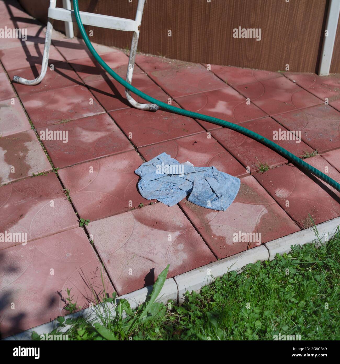wet tiled floor around an above ground swimming pool Stock Photo - Alamy