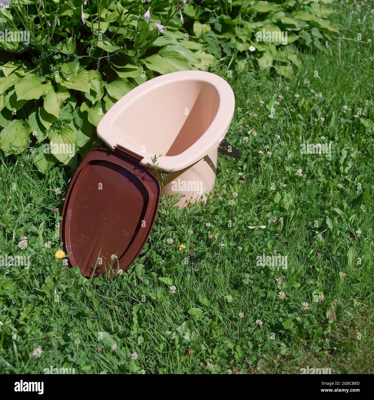 Washed plastic portable toilet drying on the sun, square composition ...