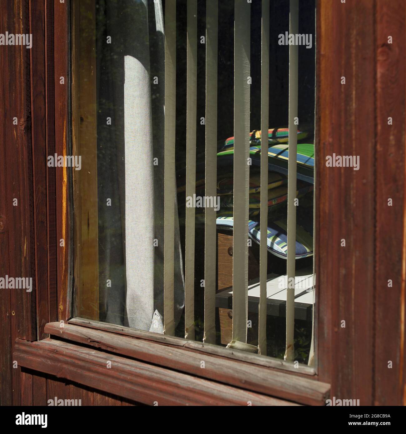 half open blinds on a window of a timber house, outdoor square ...