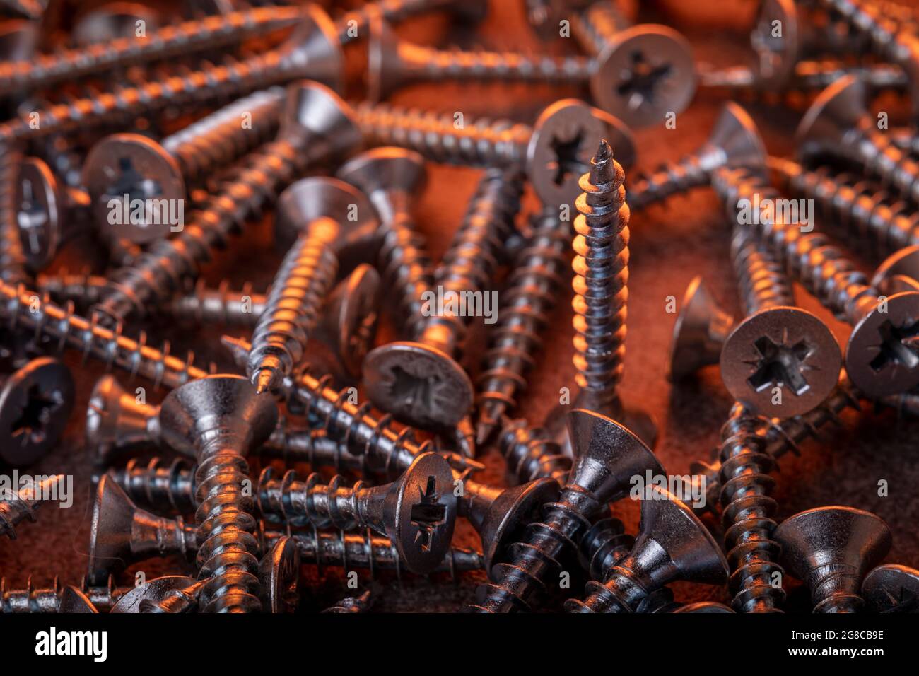 Galvanized self-tapping screws close-up in a creative color script ...