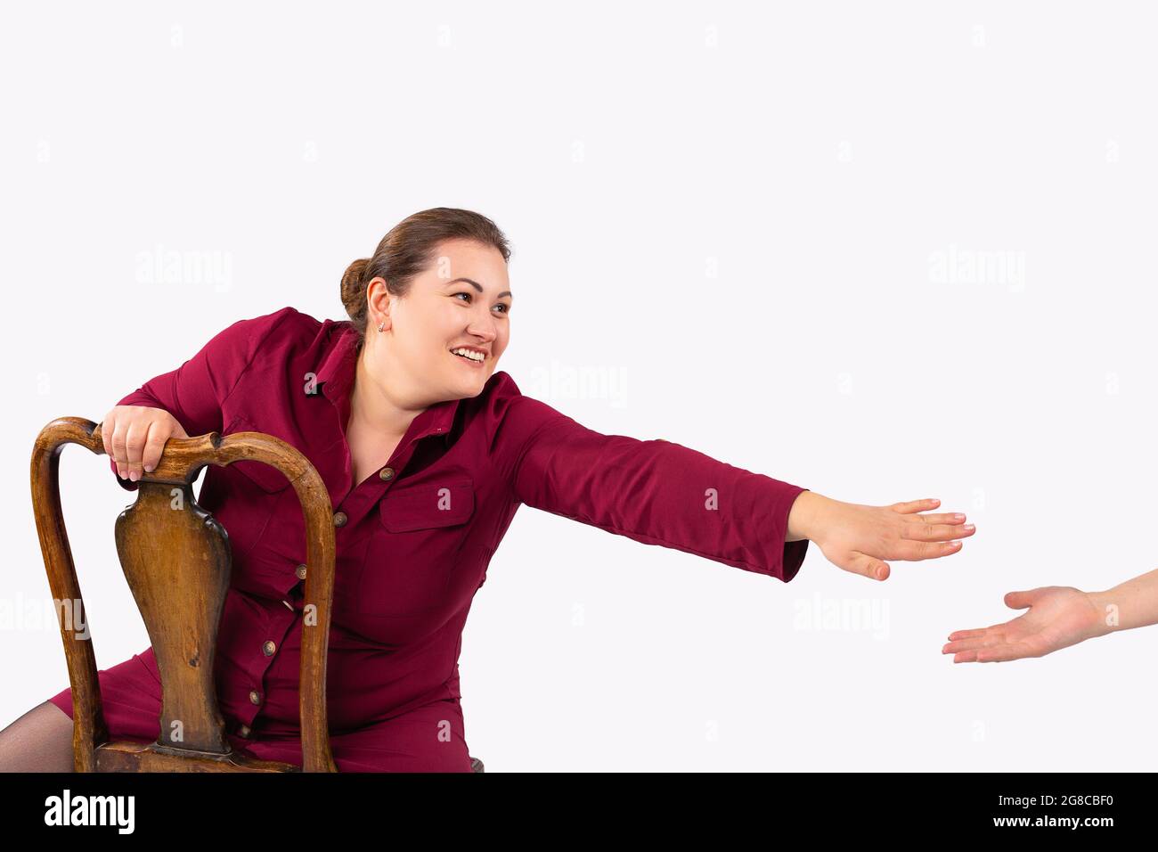 Plus size fashion model in red dress, fat woman sitting on a chair ...
