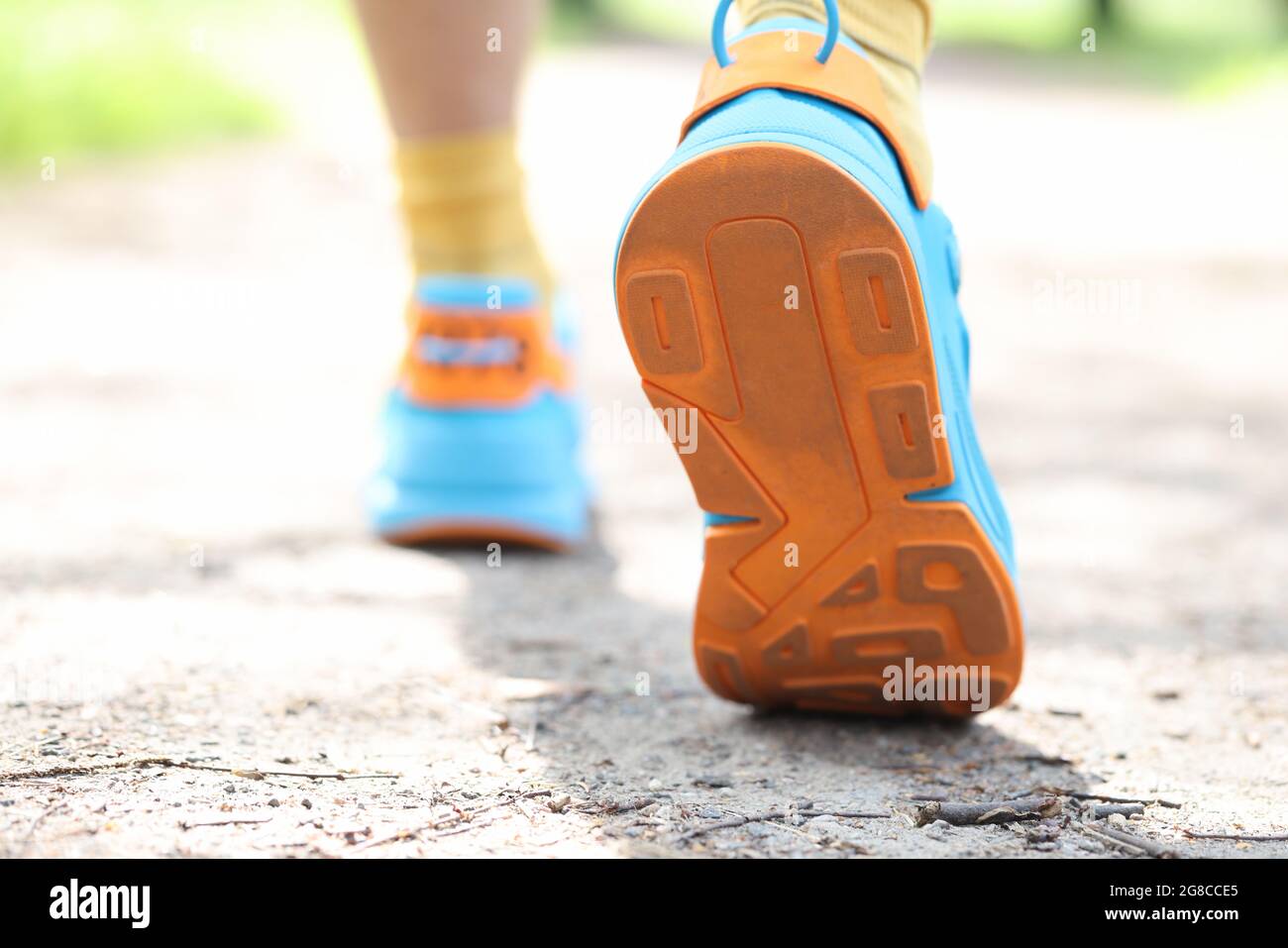 Leg of man taking step in sports sneakers closeup Stock Photo - Alamy