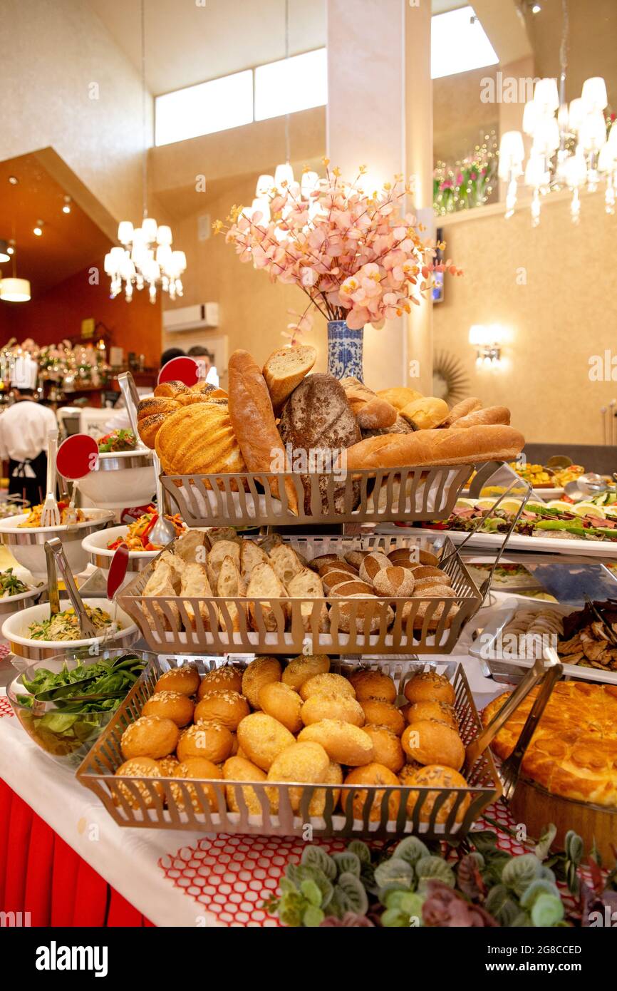 a counter with bread products on a buffet table in a restaurant Stock ...