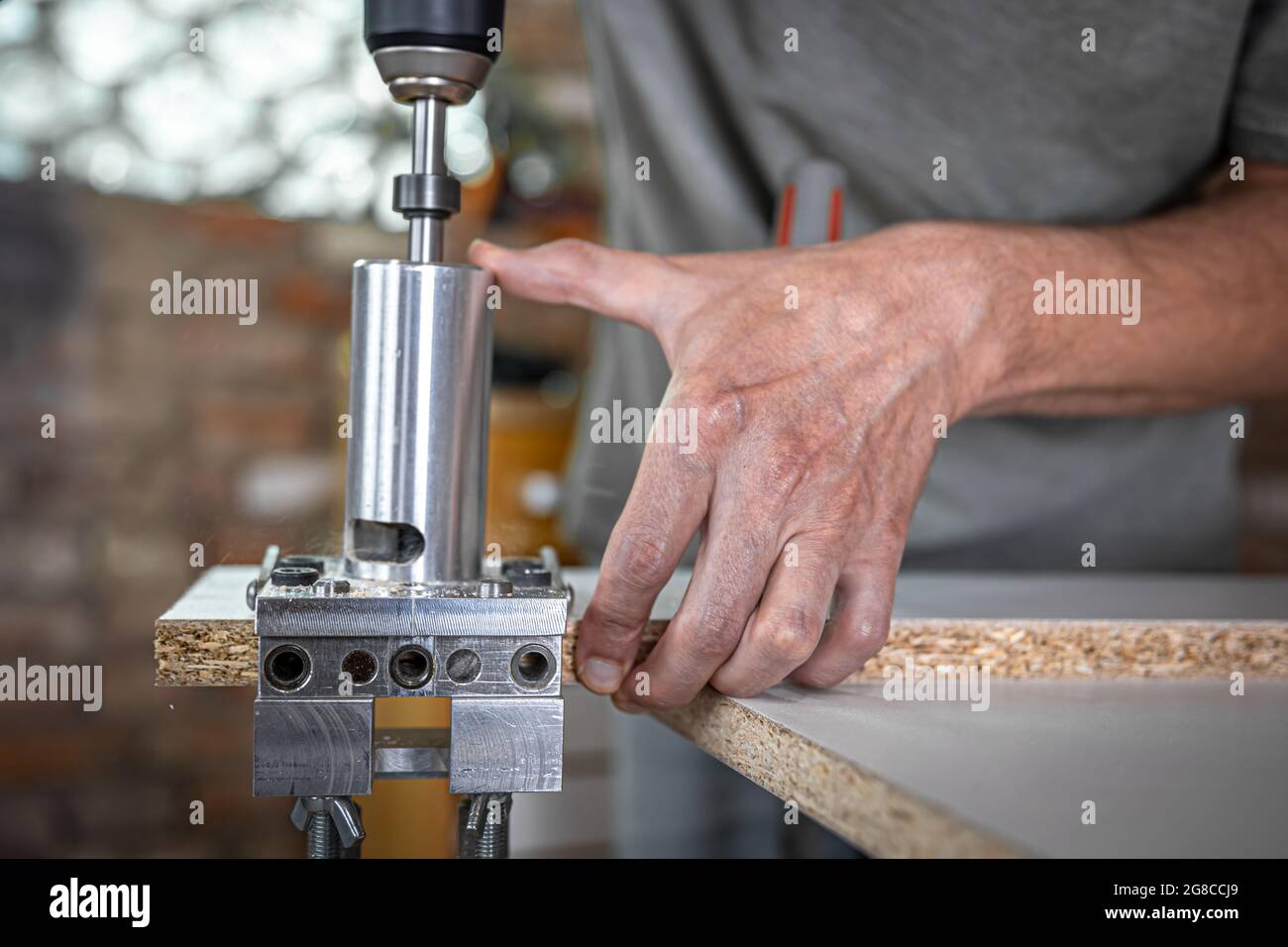 The carpenter works as a professional tool for drilling wood Stock ...