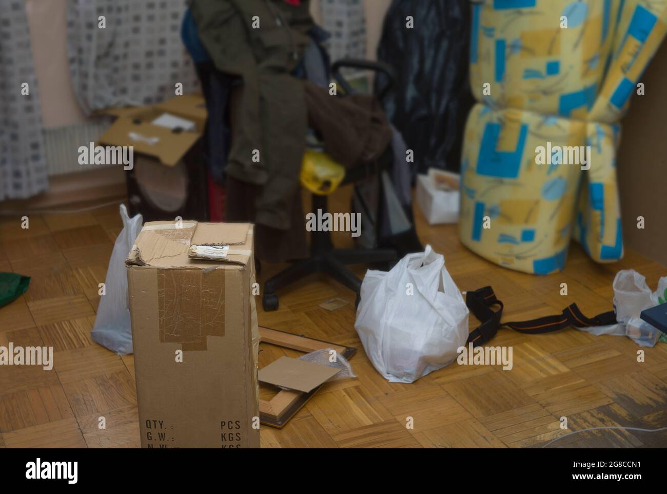 Scattered personal effects and a cardboard box in a messy room Stock ...