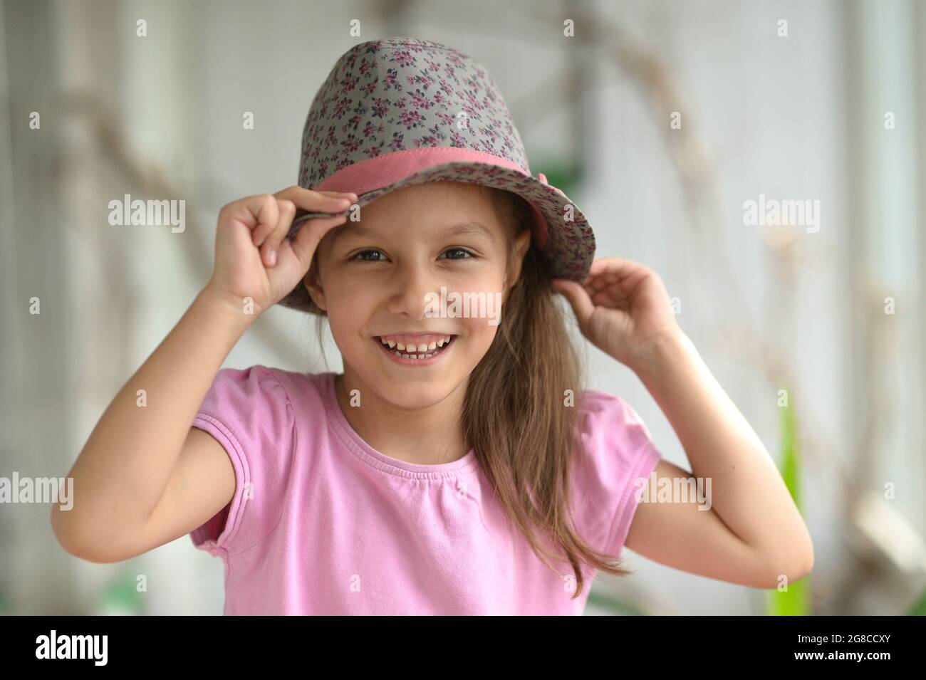 Cute little girl in hat at home Stock Photo - Alamy