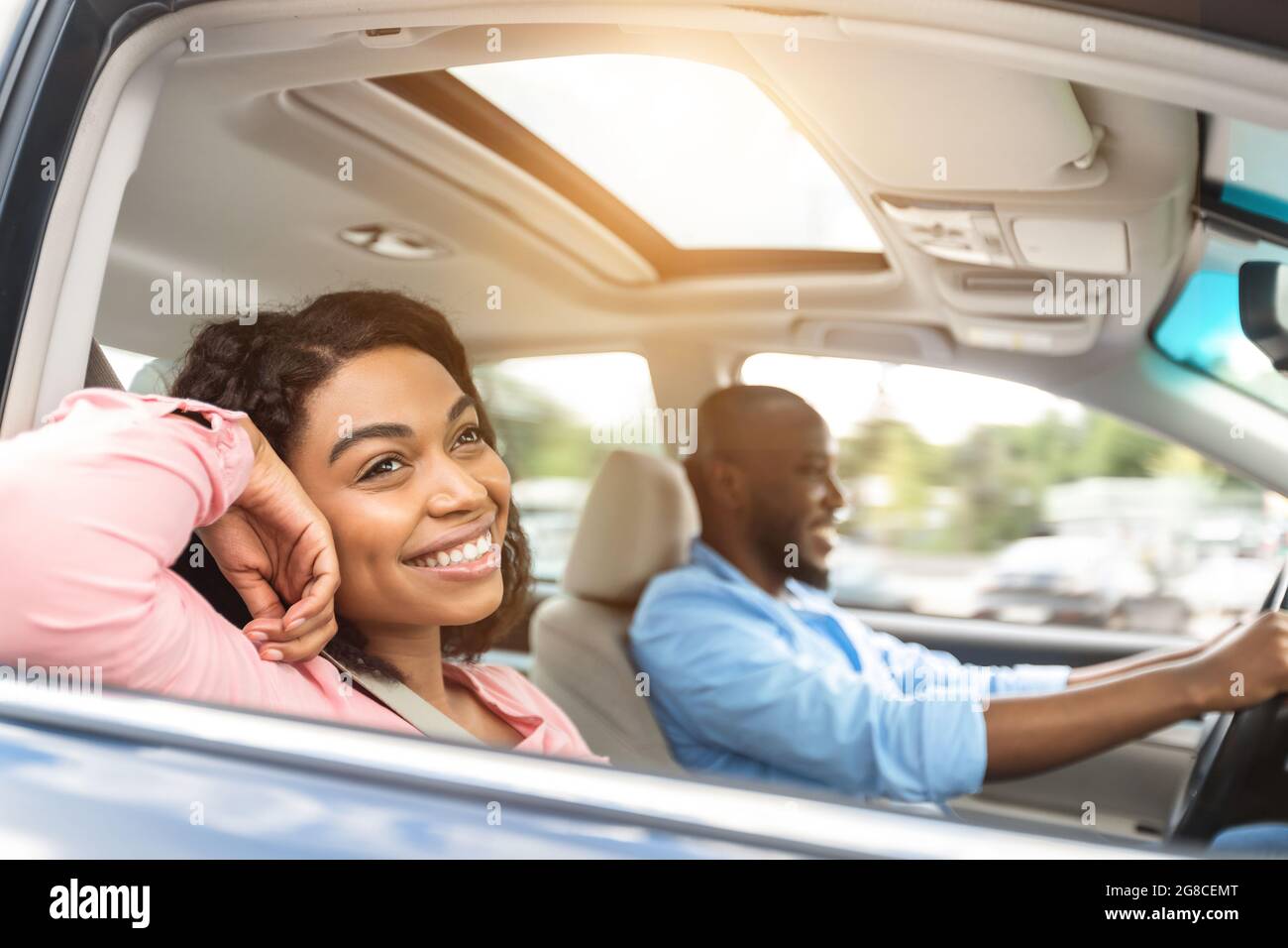 Happy black couple enjoying long drive on a car Stock Photo - Alamy