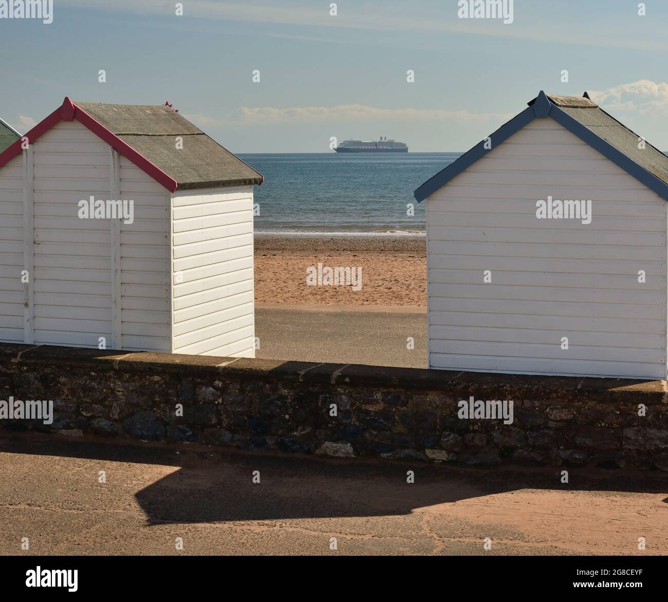 The rear of beach huts along the seafront at Goodrington Sands, with a ...