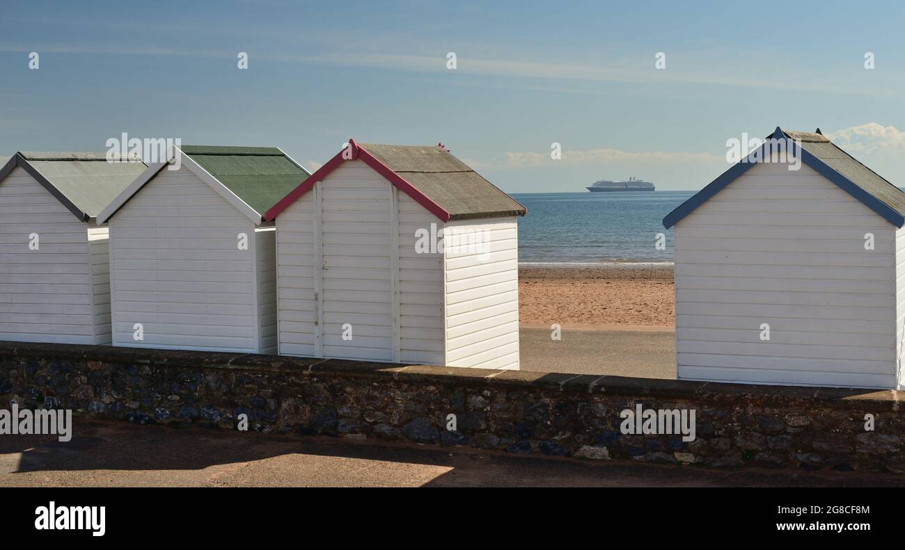 The rear of beach huts along the seafront at Goodrington Sands, with a ...