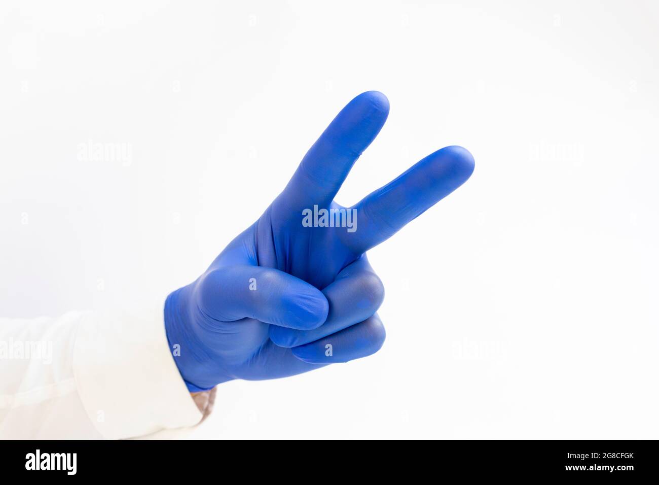 Hand in blue latex Glove raising two fingers up on hand it is shows ...