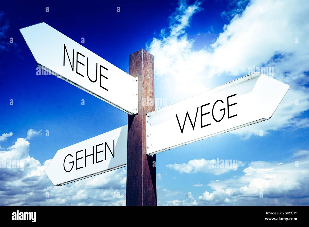 Neue Wege gehen (German)/ Go new ways (English) - signpost with three ...