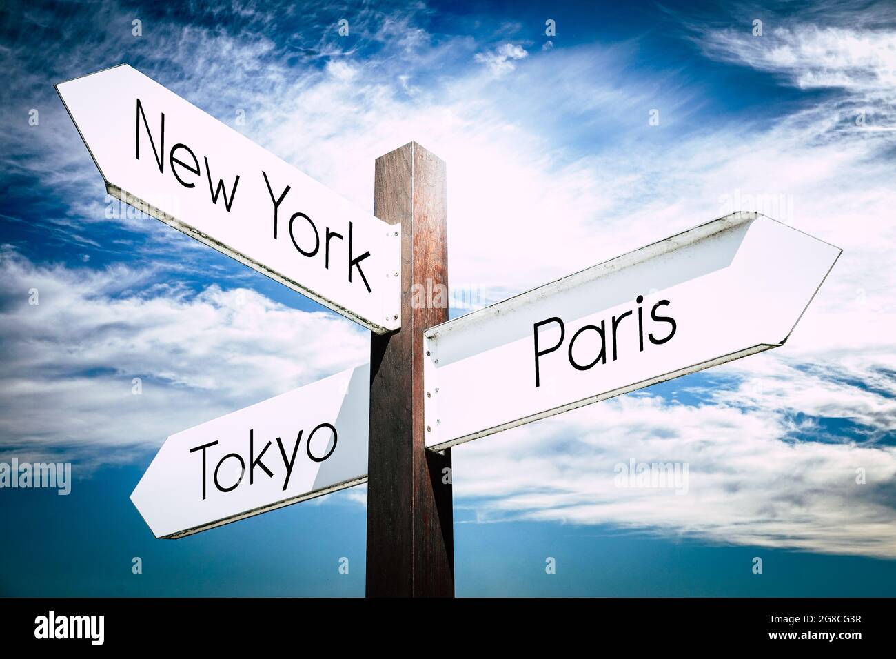 New York, Paris, Tokyo concept - signpost with three arrows Stock Photo ...