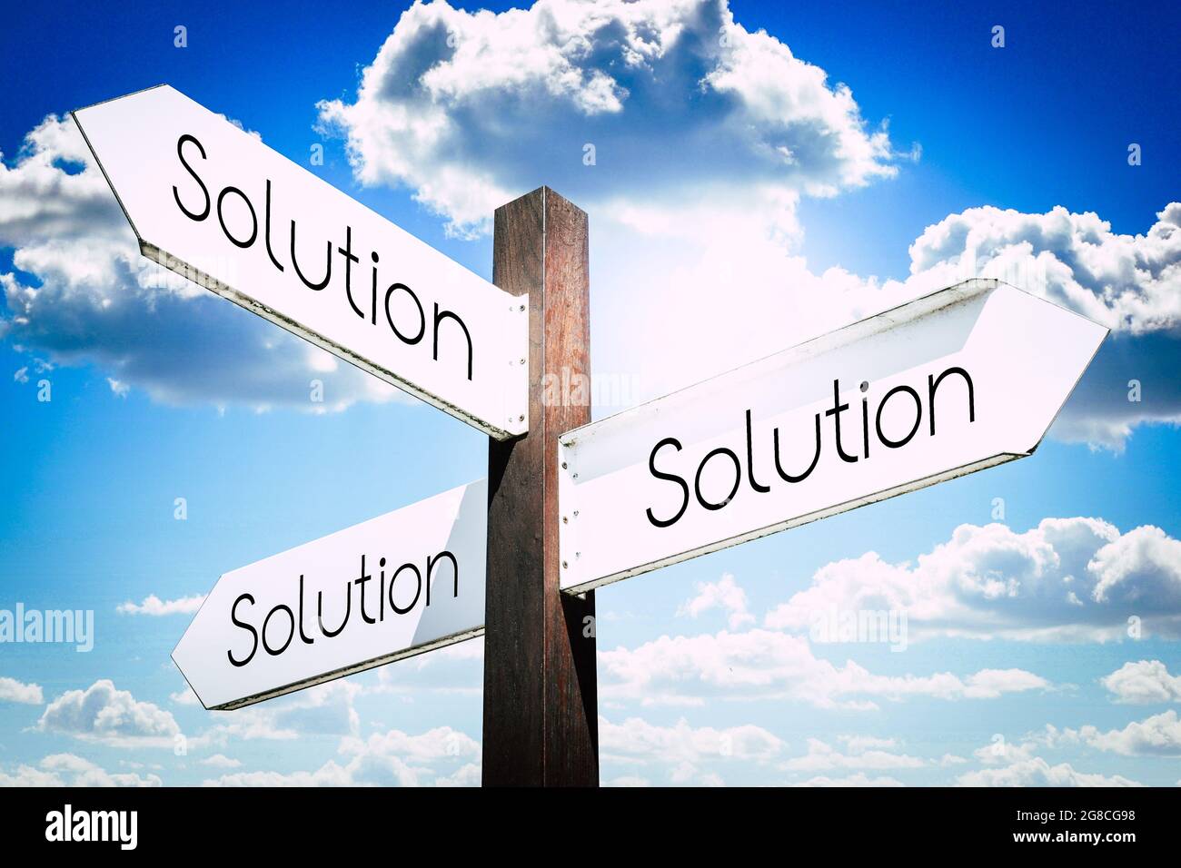 Solution concept - signpost with three arrows Stock Photo - Alamy