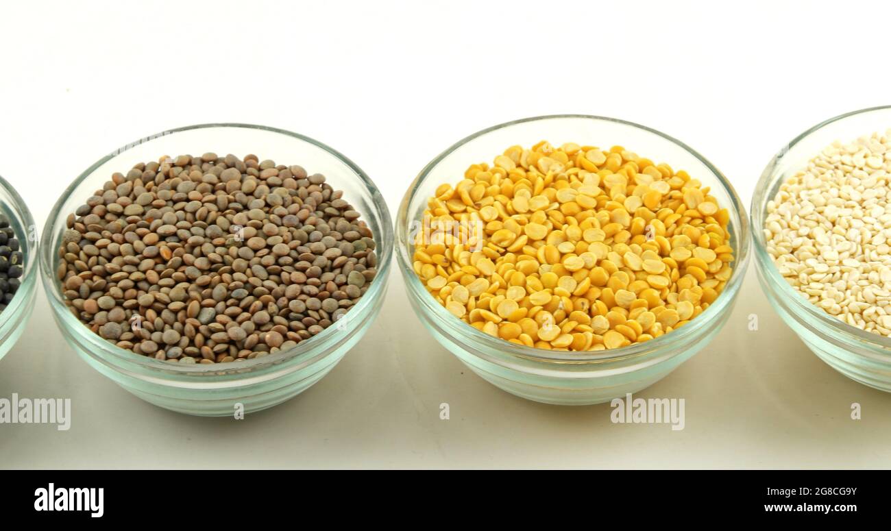 Closeup shot of various lentils in plates isolated on a white ...