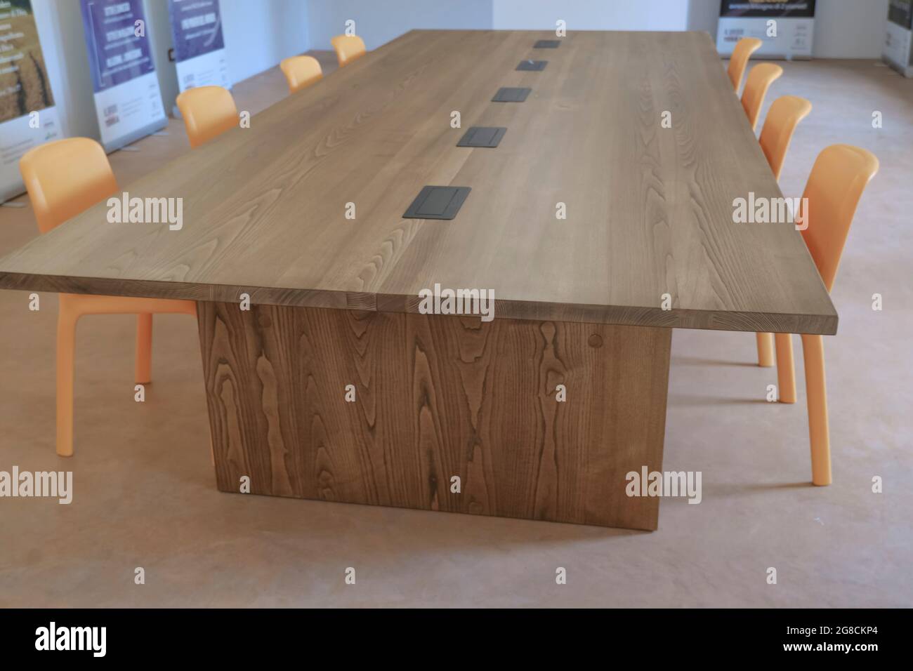 Wooden table and orange chairs in the office. Empty office. Office ...