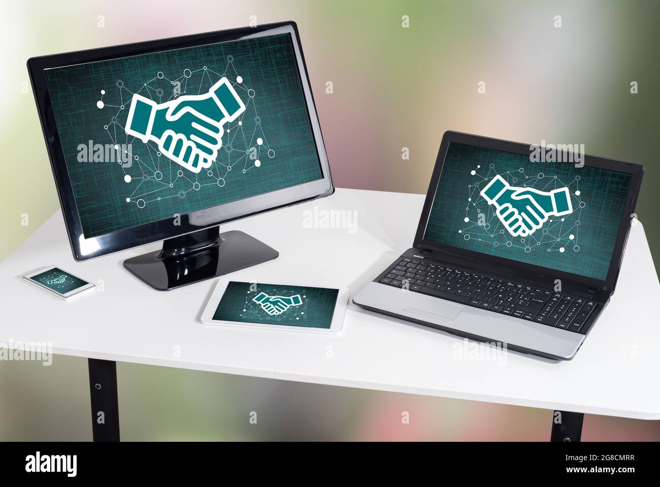 Business partnership concept shown on different information technology ...