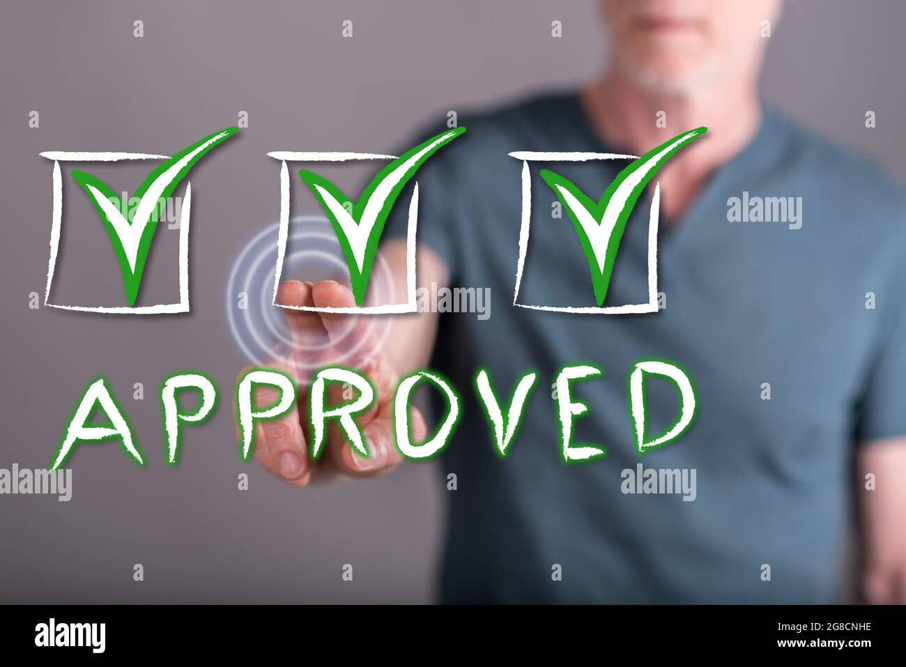 Man touching a validation concept on a touch screen with his finger ...