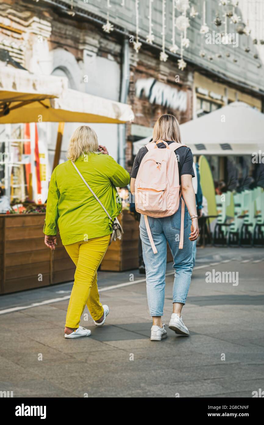 Two woman walking backview hi-res stock photography and images - Alamy