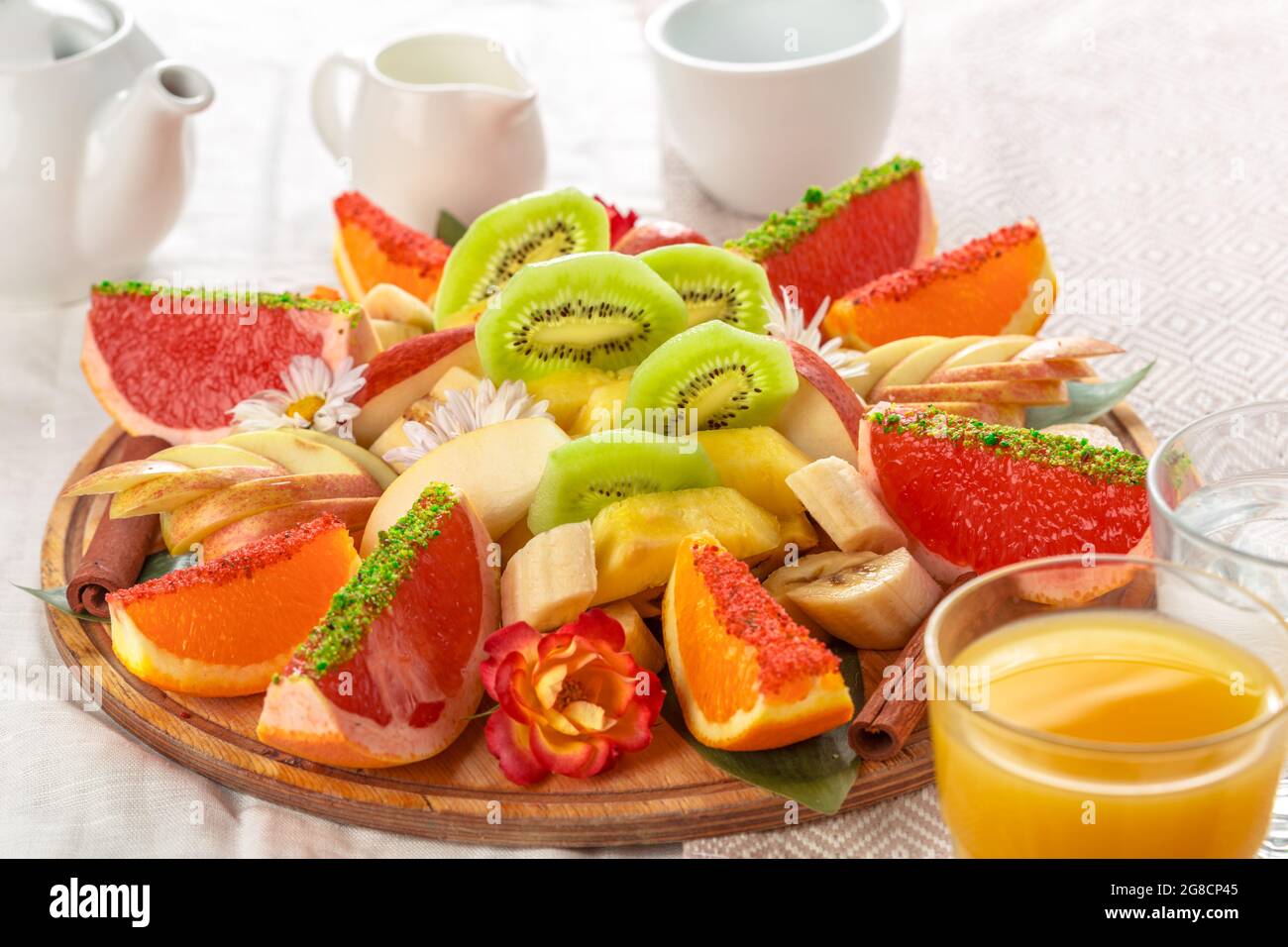 Assorted sliced tropical fruits on plate hi-res stock photography and ...