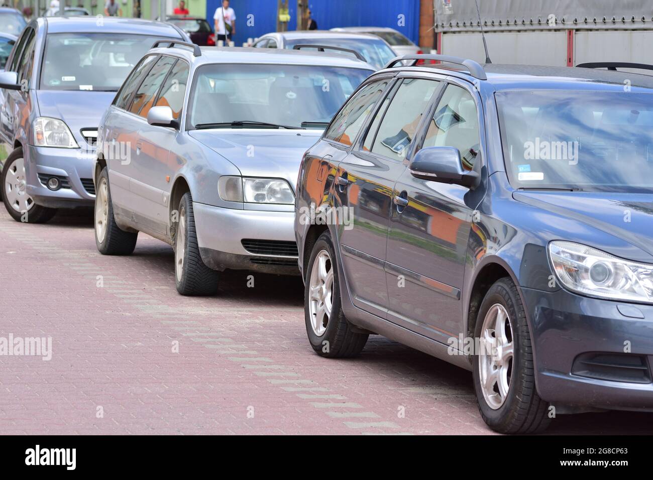 Cars and vehicles are parked on a busy street. Summer Stock Photo - Alamy