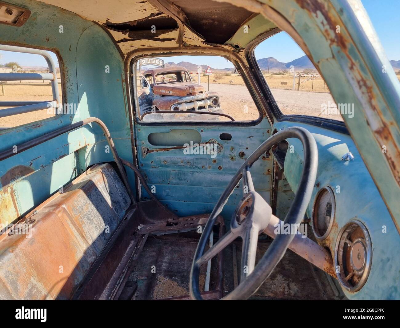 Old broken vintage car dumped in a desert Stock Photo - Alamy