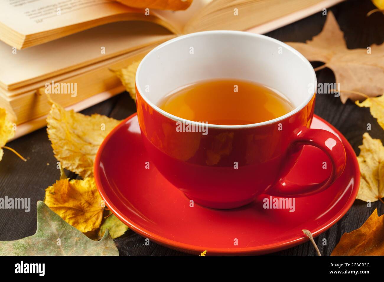 Autumn leaves, book and cup of tea Stock Photo - Alamy