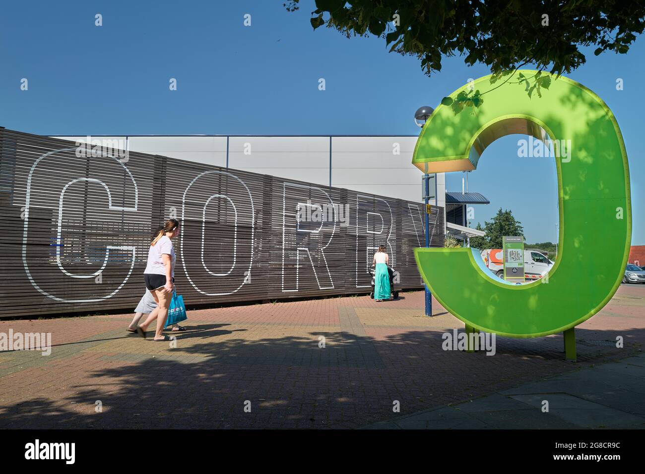 Shoppers leave the shopping complex at Corby town centre, England Stock ...