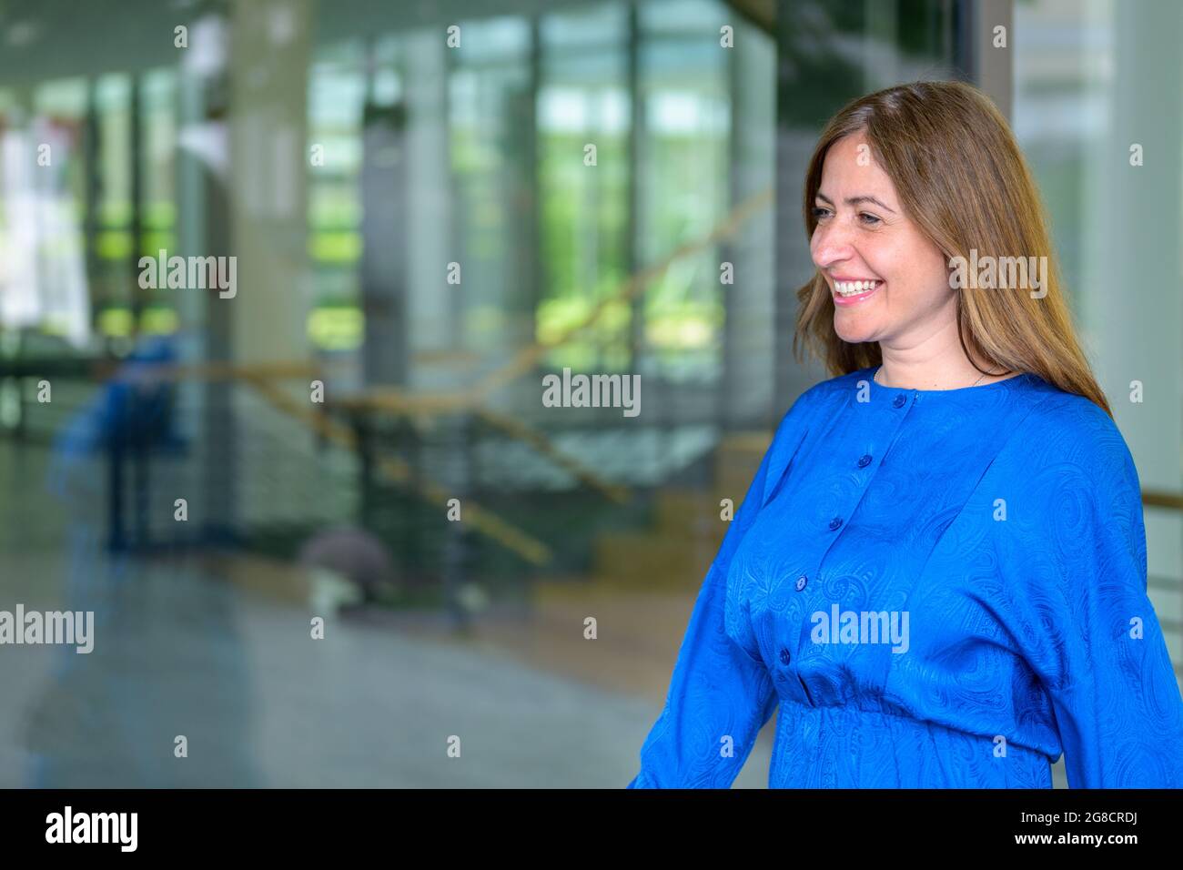 Businesswoman walking forwards to welcome a client with a warm friendly ...