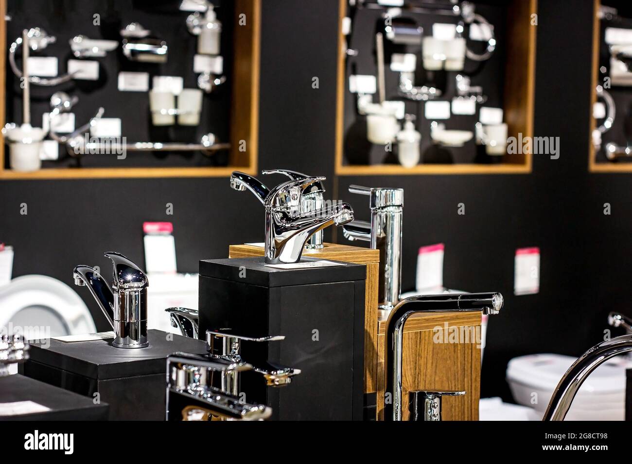 New modern metal water faucets for bathroom on the shop display stands ...