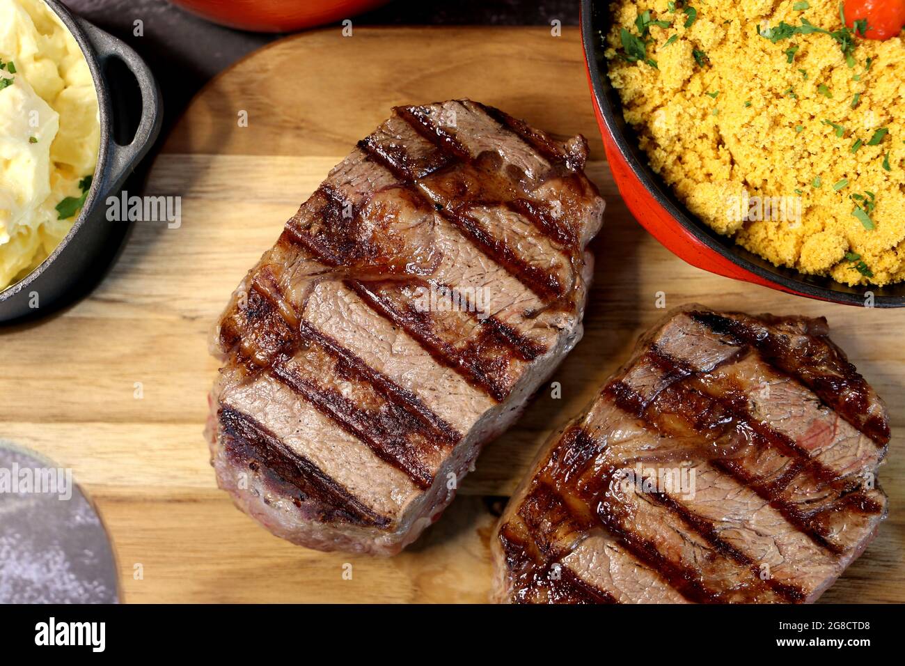 Delicious juicy Ancho steak with grill marks and accompaniment of ...