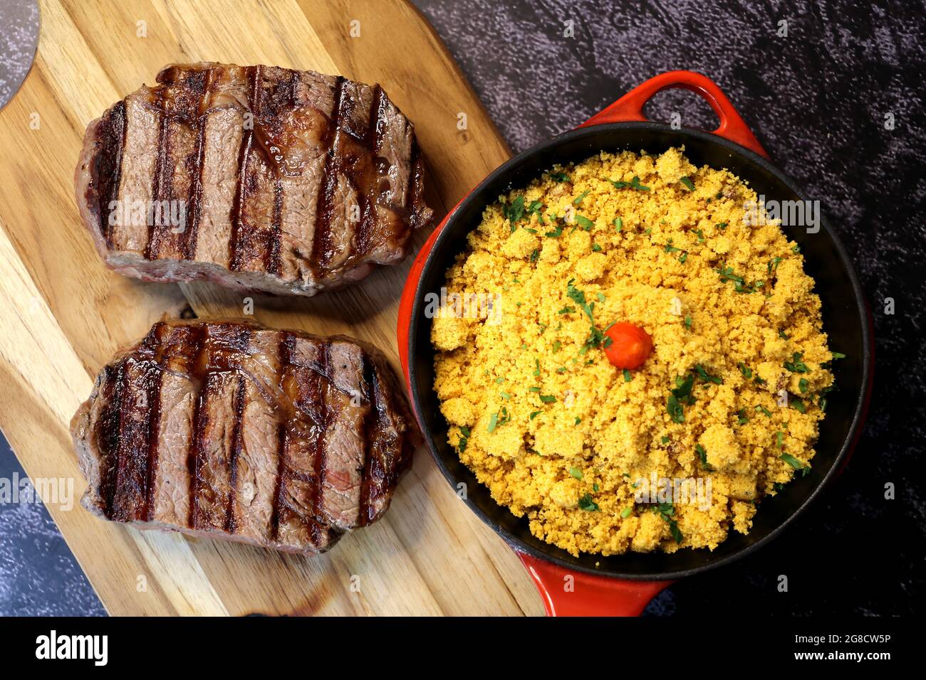 Delicious juicy Ancho steak with grill marks and accompaniment of ...