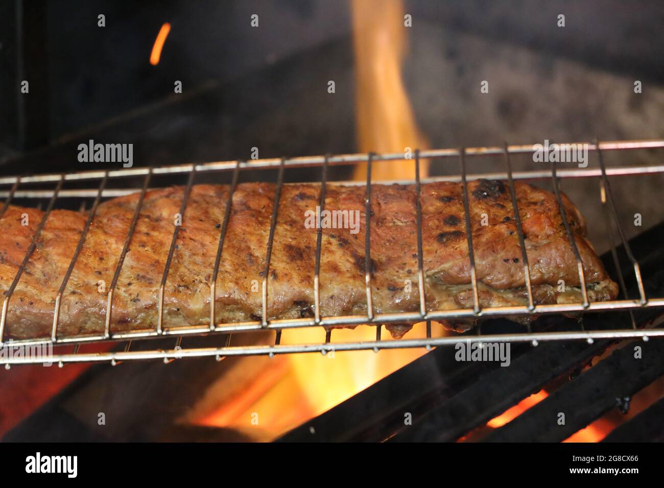 Ribs pork in brazilian barbecue. With fire background. Close up Stock ...