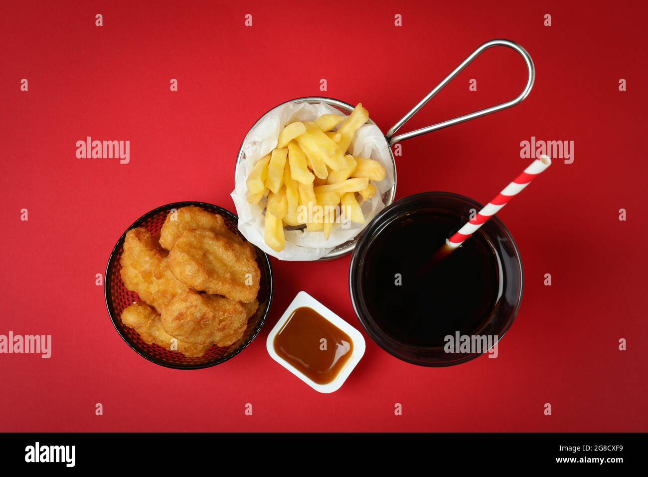 Concept of fast food on red background Stock Photo - Alamy