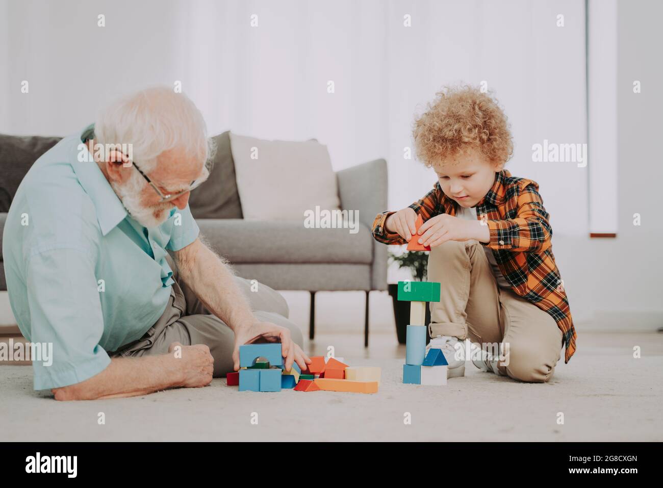 Grandparents and grandson playing at home - Family at home, grandfather ...